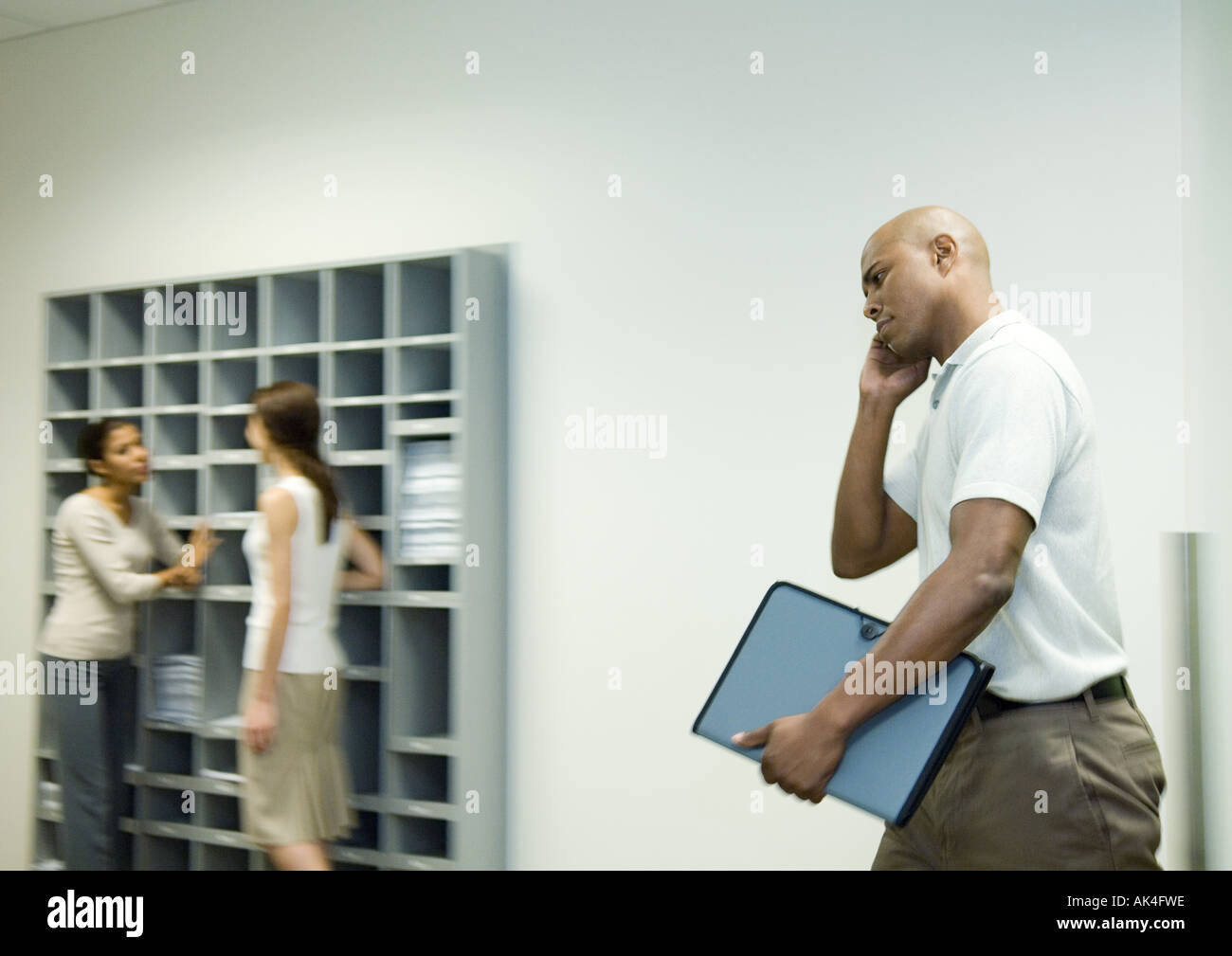 Three women talking folders hi-res stock photography and images - Alamy