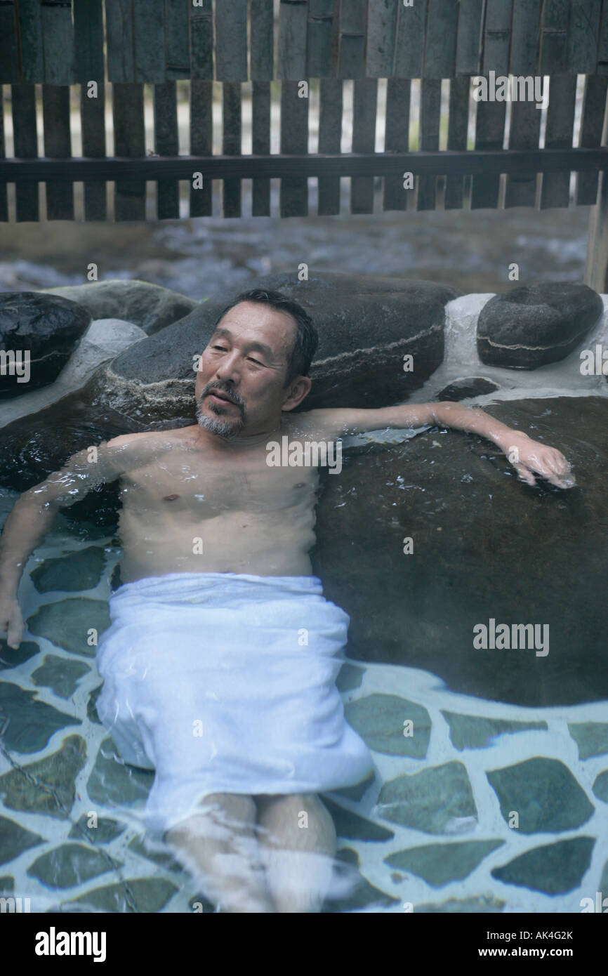 Elderly man in hot spring Stock Photo - Alamy