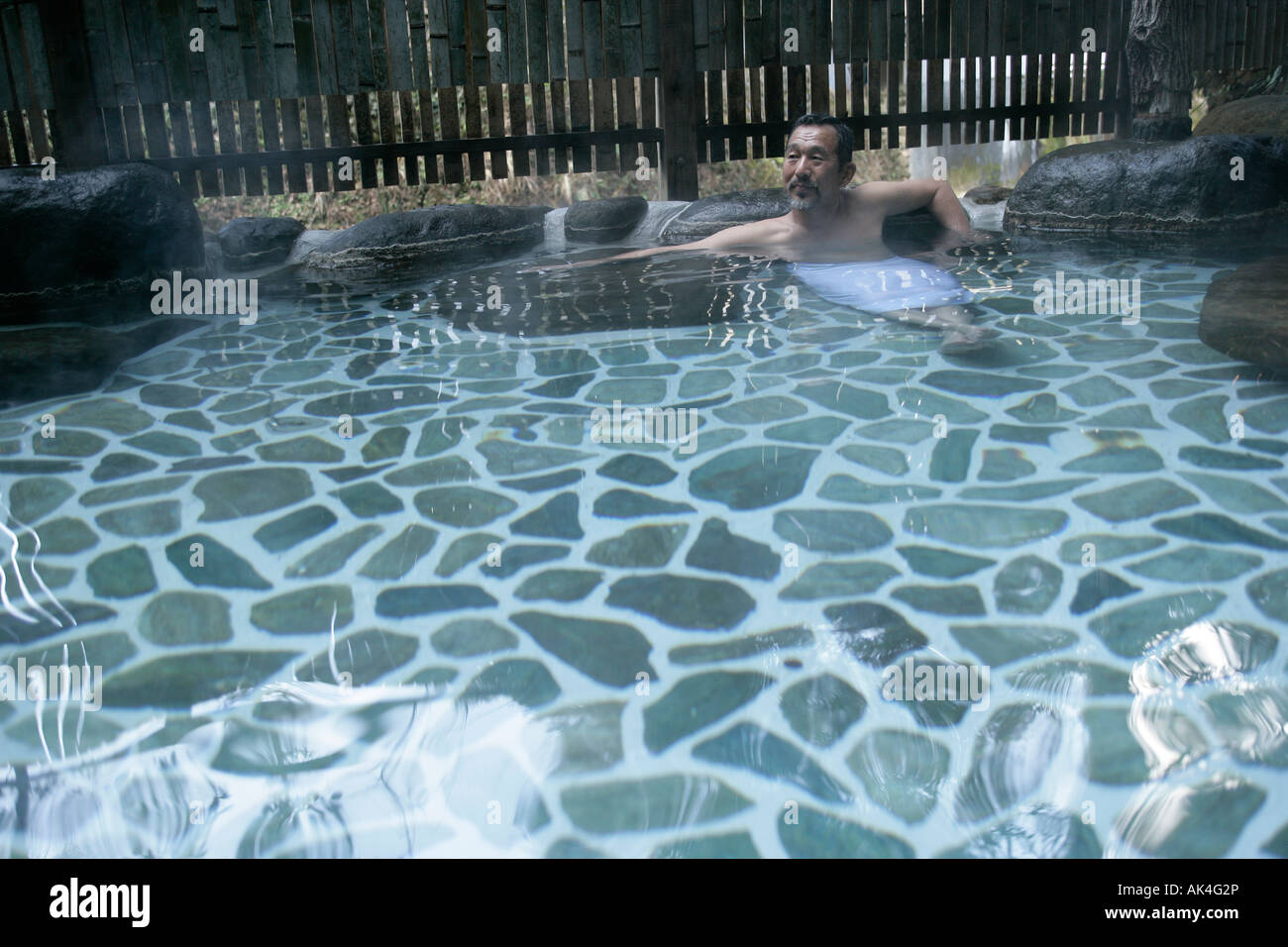 Elderly man in hot spring Stock Photo - Alamy