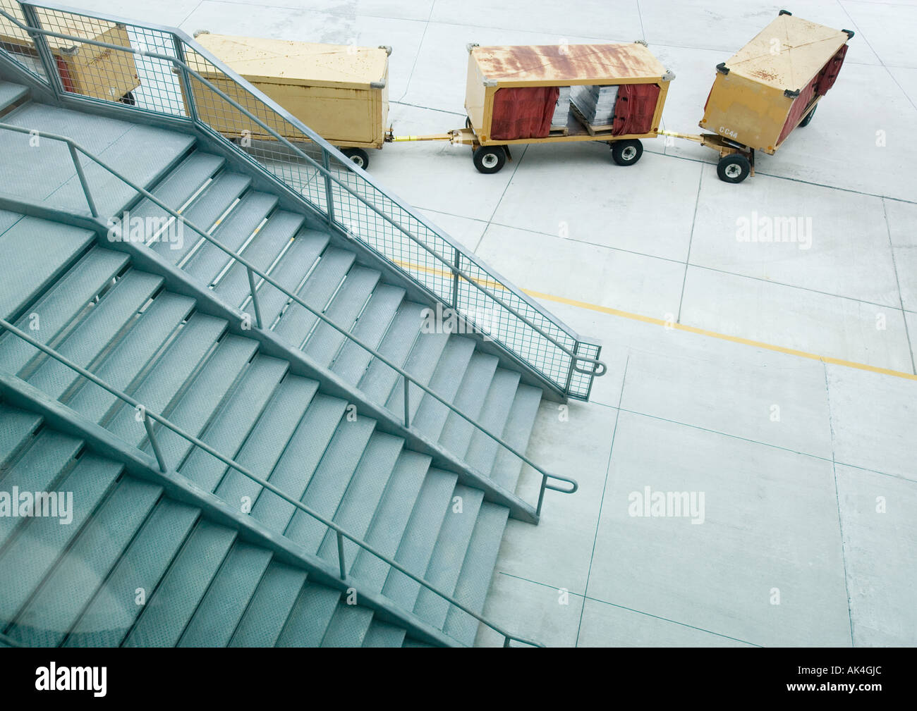 Stairs and cargo containers on tarmac Stock Photo - Alamy