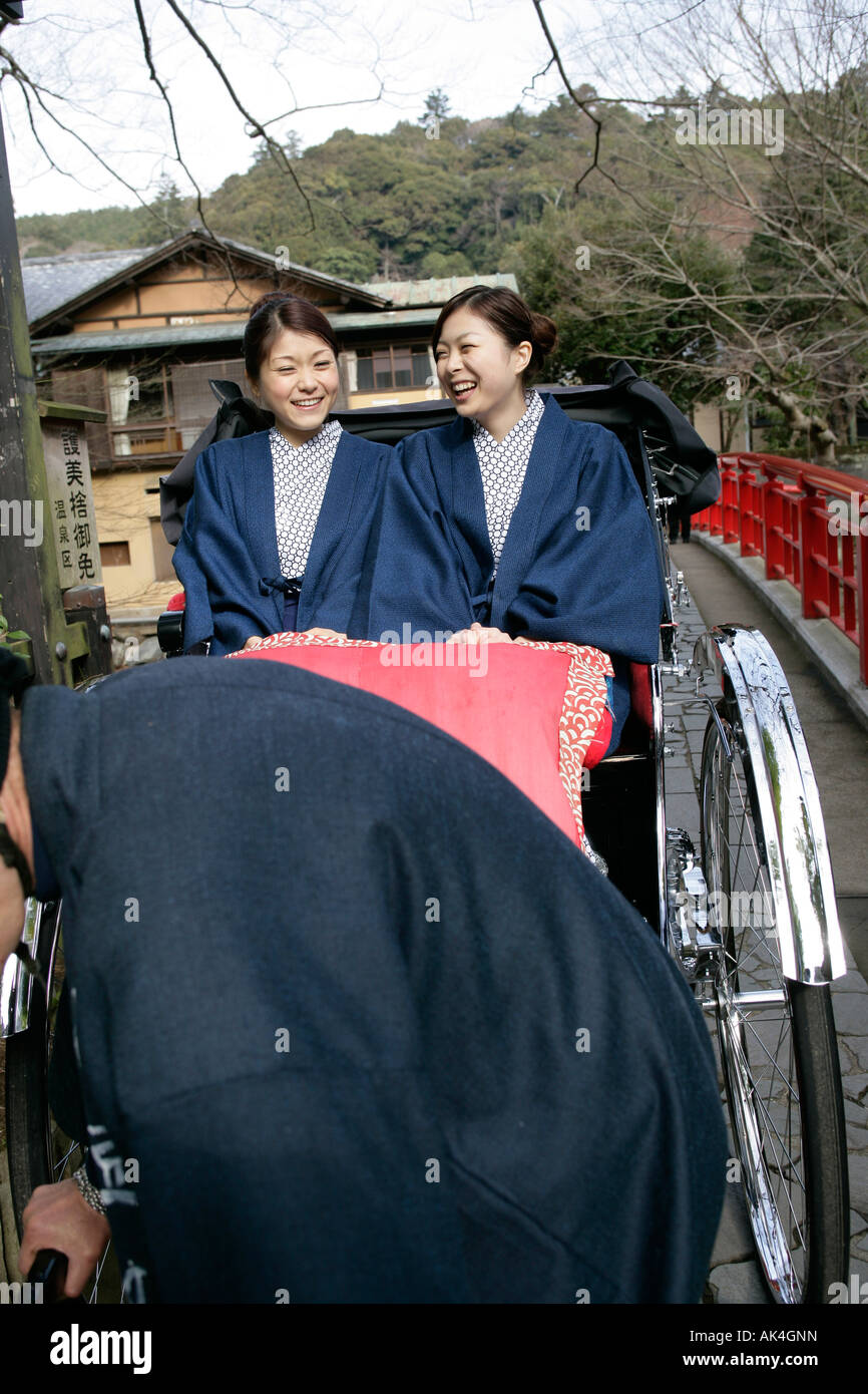 Two women sitting on a rickshaw Stock Photo - Alamy