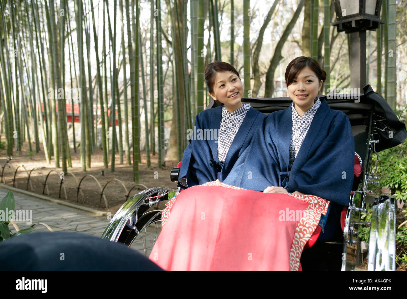 Two women sitting on a rickshaw Stock Photo - Alamy
