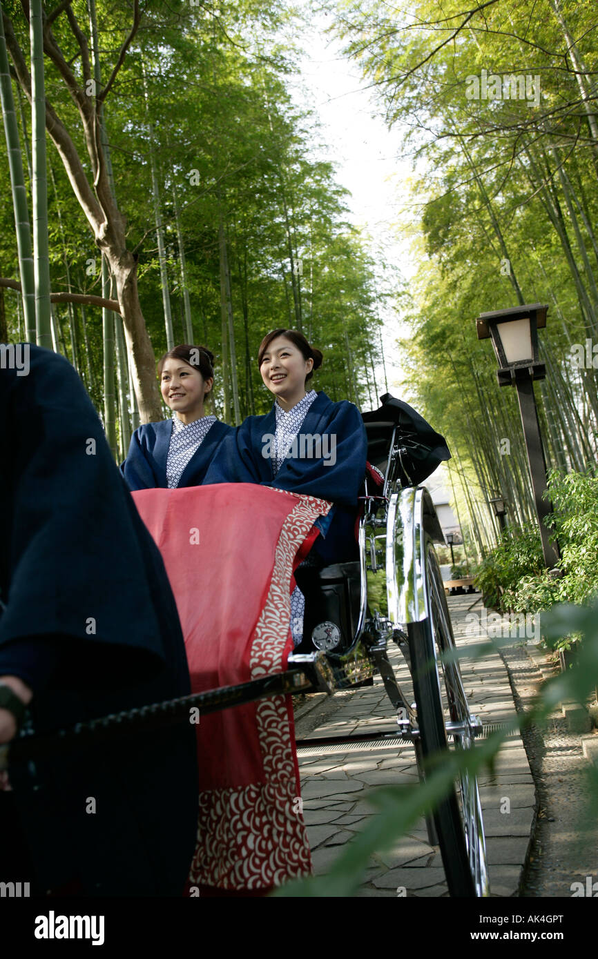 Two women sitting on a rickshaw Stock Photo - Alamy
