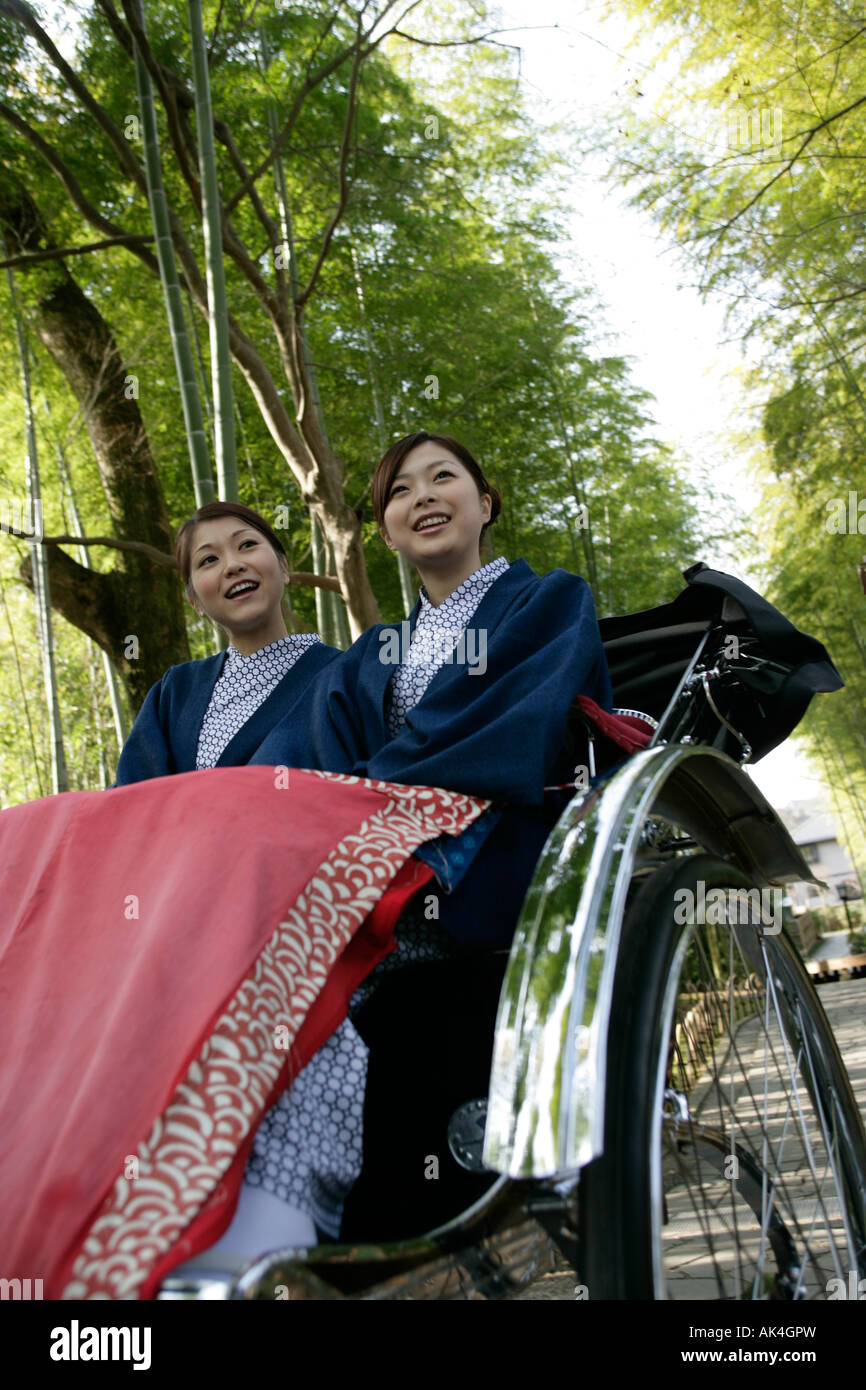 Two women sitting on a rickshaw Stock Photo - Alamy