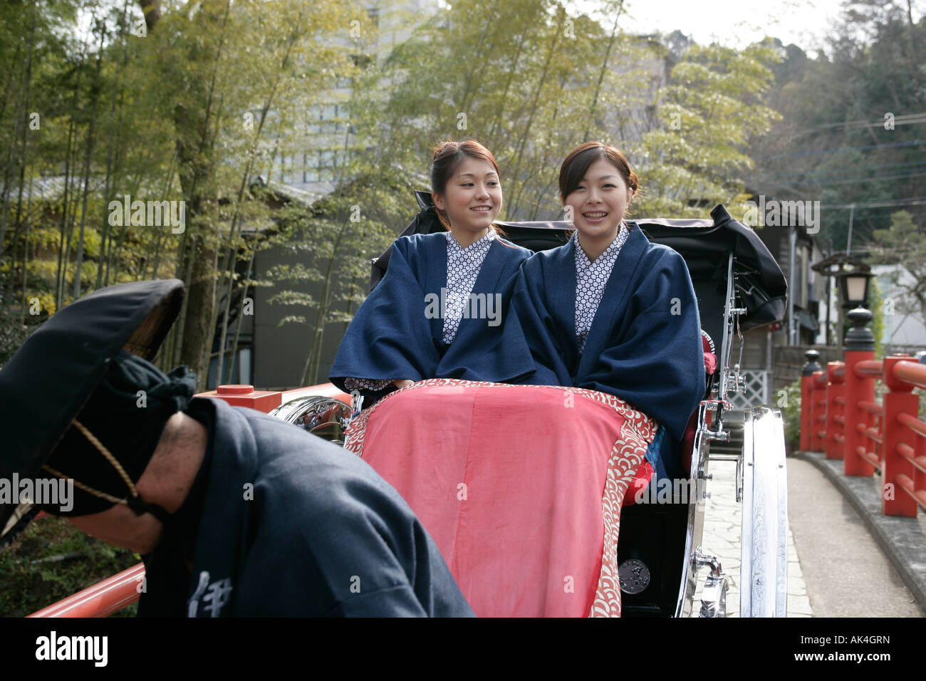 Two women sitting on a rickshaw Stock Photo - Alamy