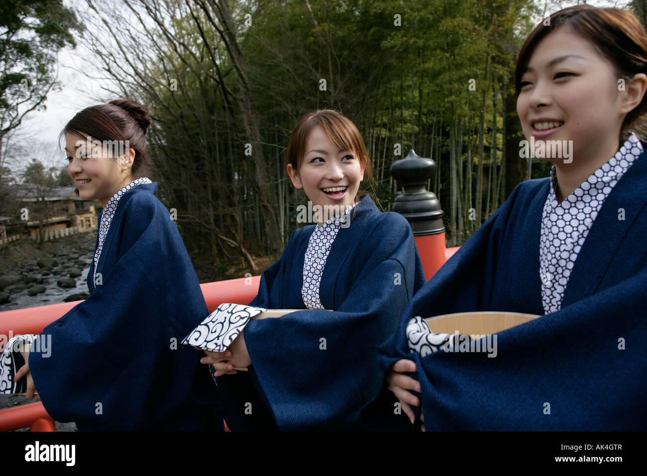 Three women with buckets, walking on bridge, close-up Stock Photo - Alamy