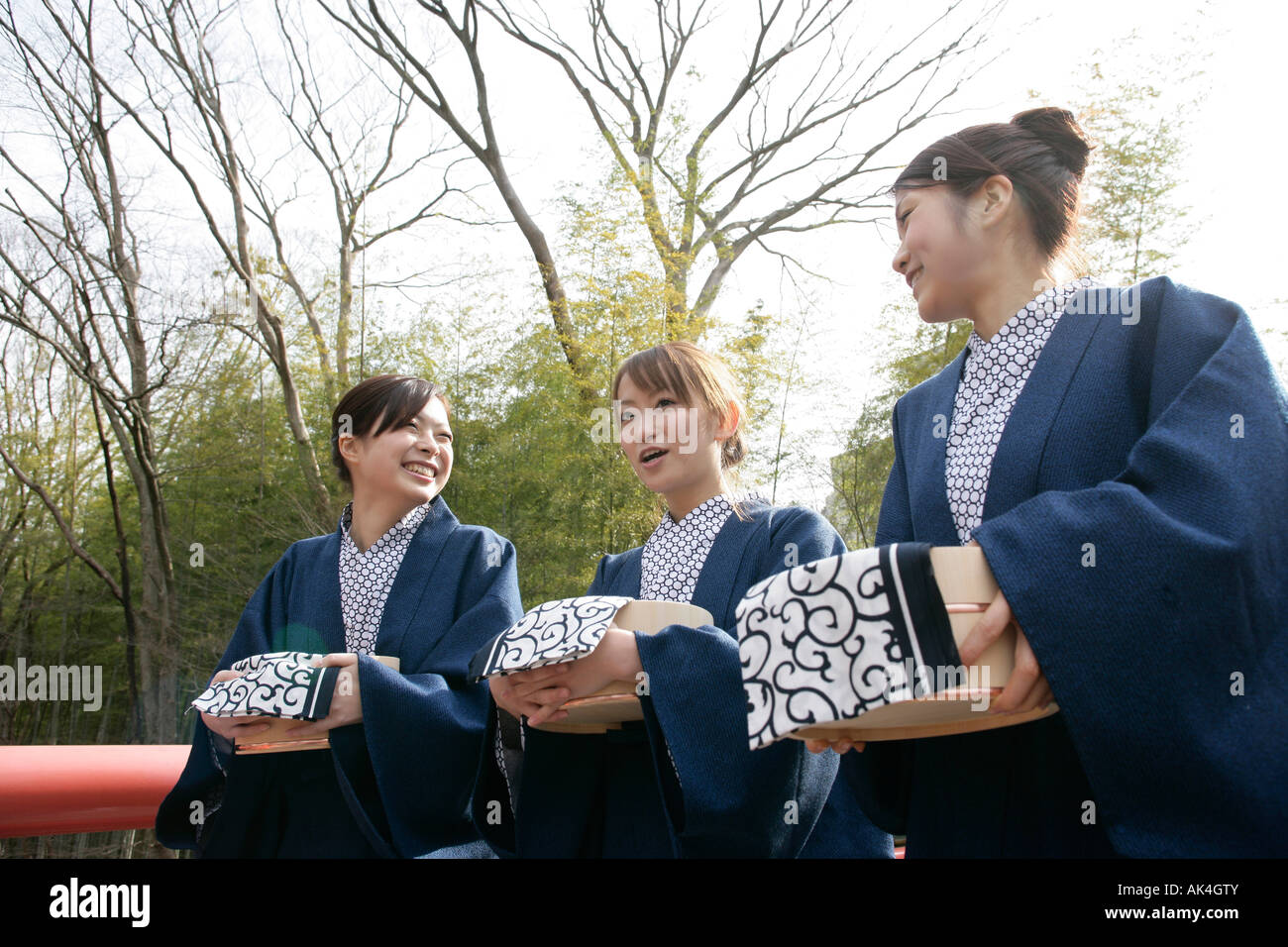 Three women with buckets, walking on bridge, low angle Stock Photo - Alamy