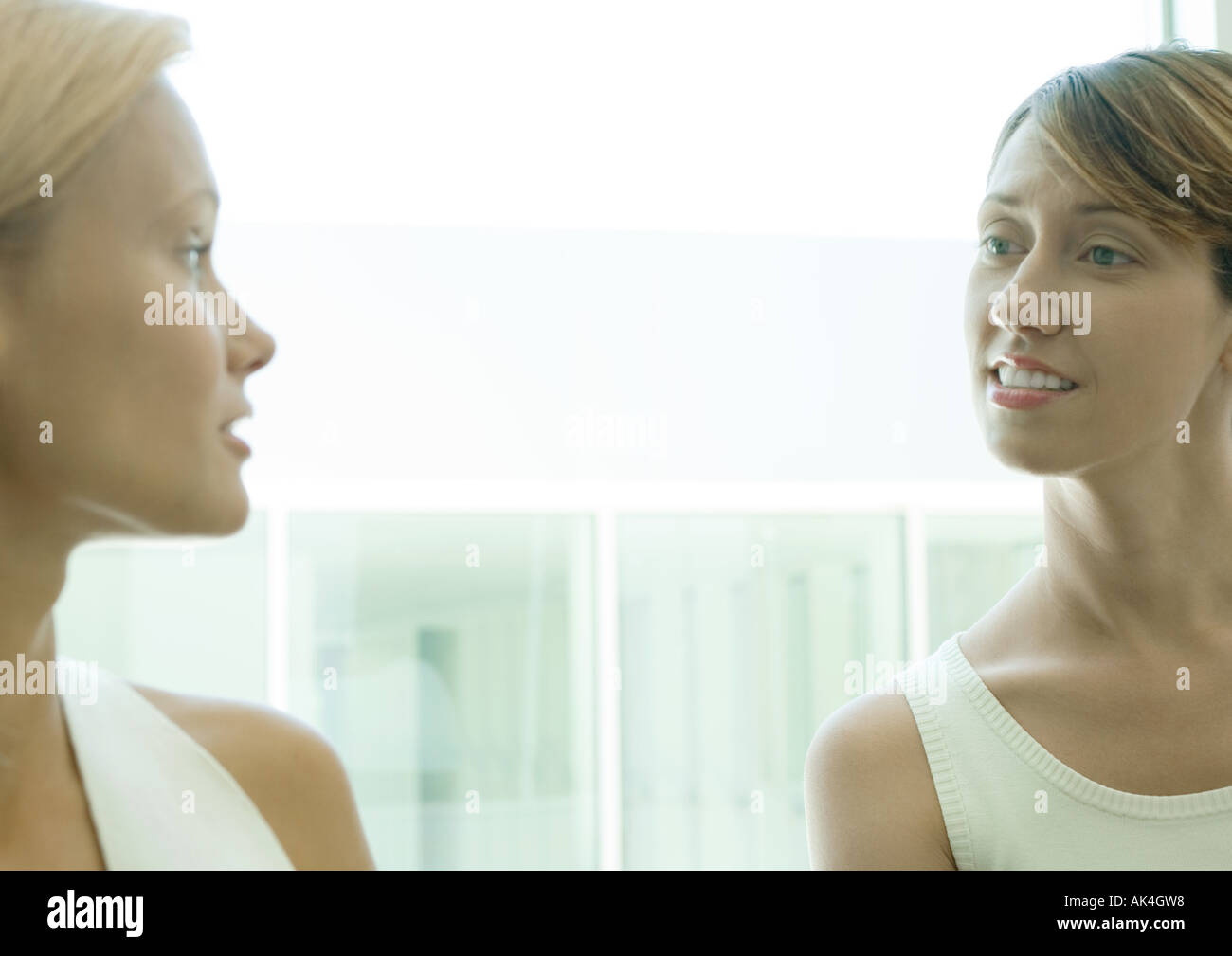 Two women speaking to each other Stock Photo - Alamy
