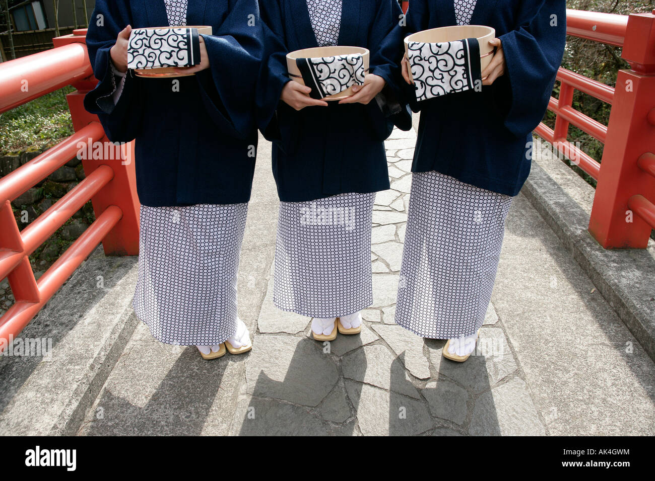 Three women with buckets, standing on bridge Stock Photo - Alamy