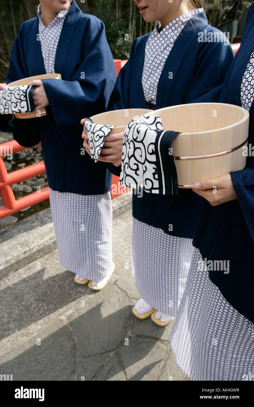 Three women with buckets, standing on bridge Stock Photo - Alamy