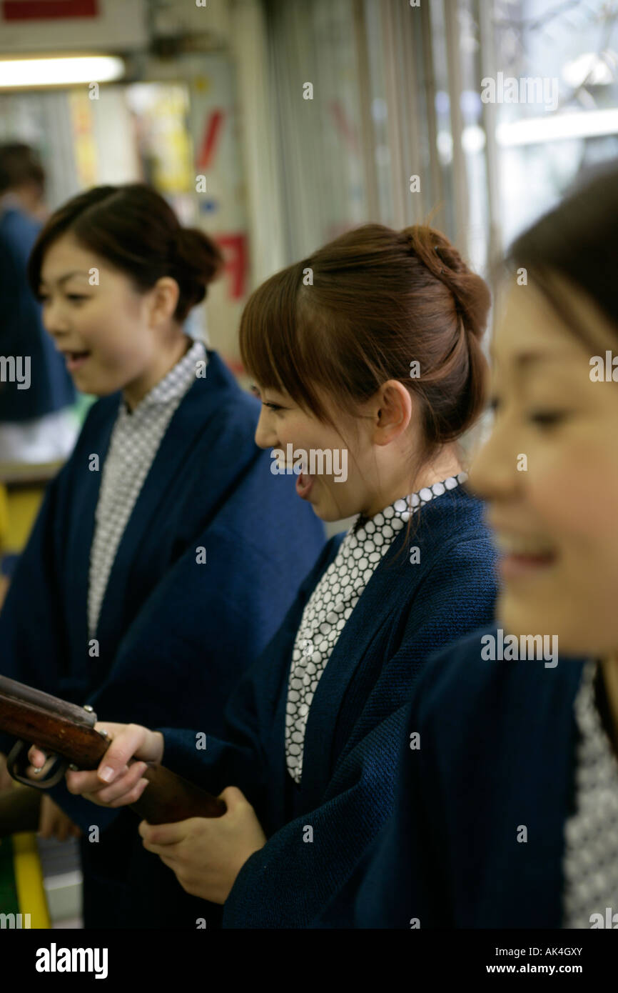Three women in amusement arcade Stock Photo - Alamy