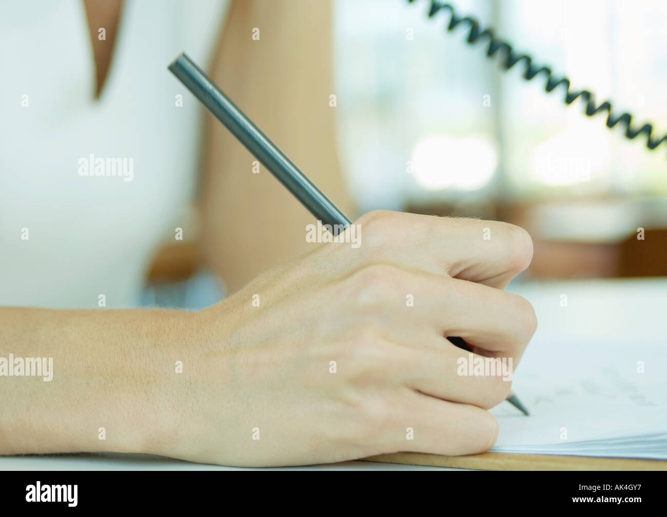 Woman using phone and taking notes, close-up of hand Stock Photo - Alamy