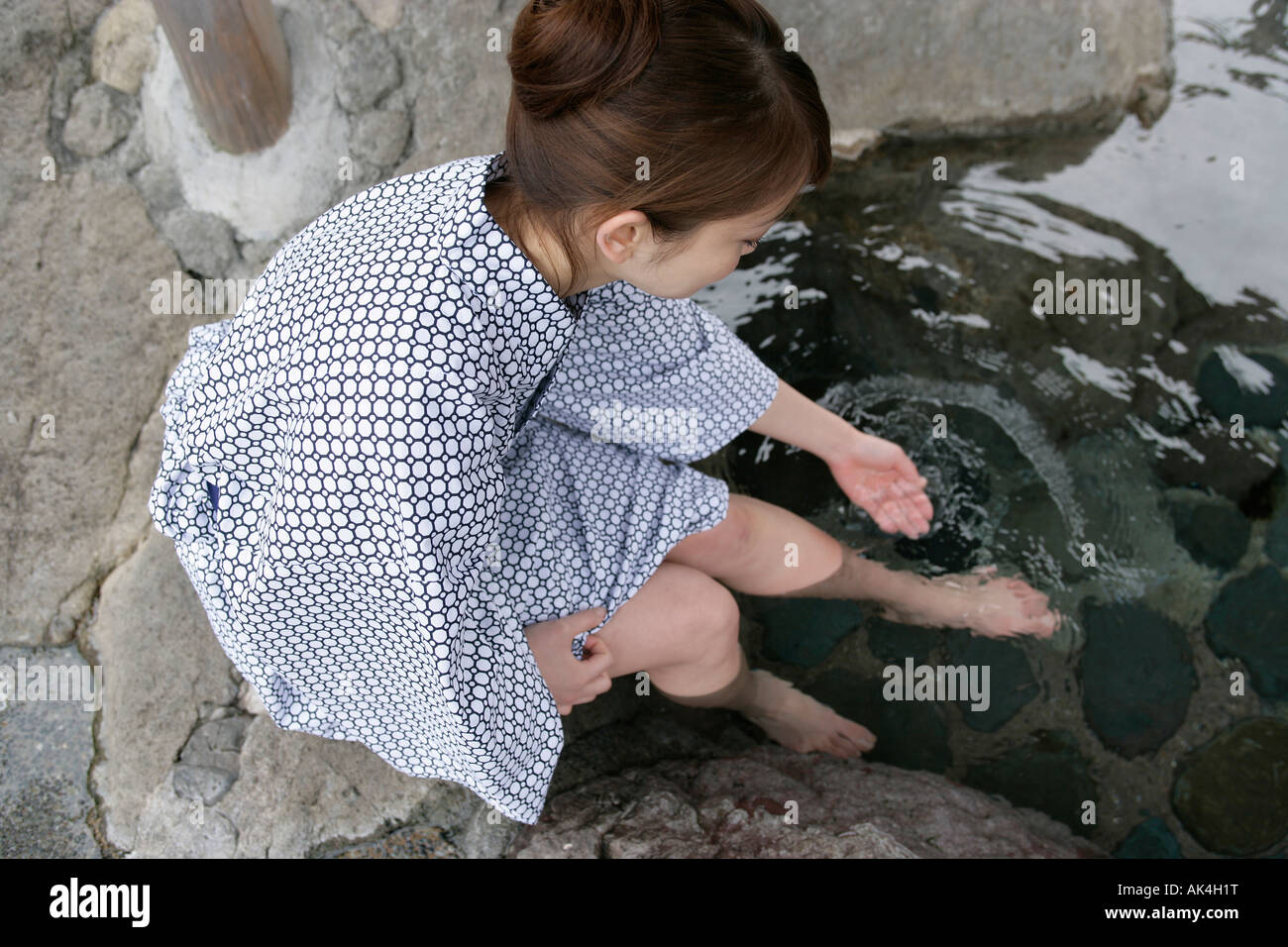 Woman soaking her feet in hot spring, elevated view Stock Photo - Alamy