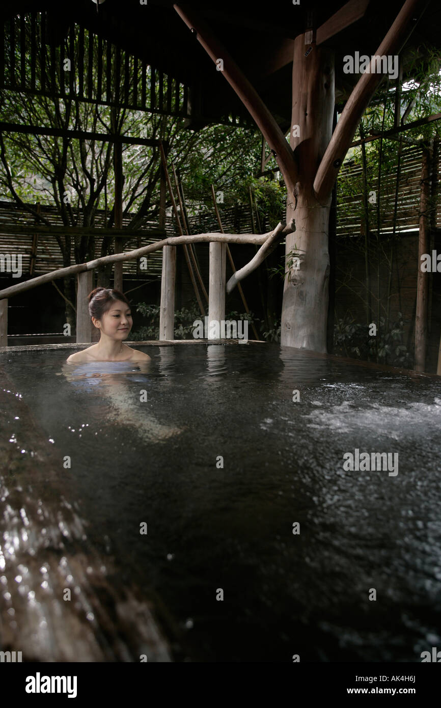 Woman soaking in hot tub Stock Photo - Alamy