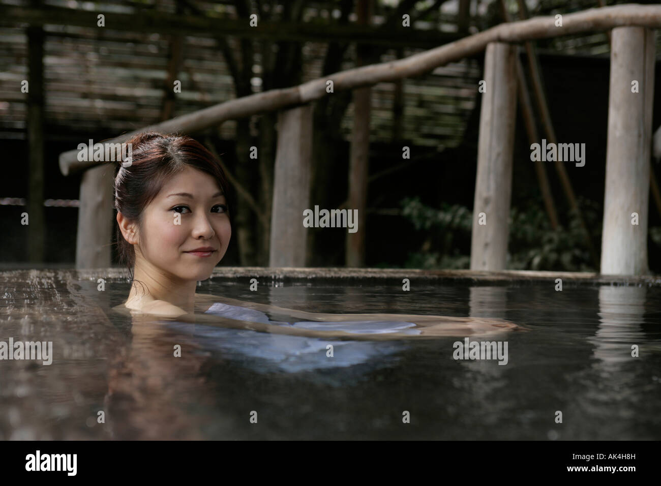Woman soaking in hot tub Stock Photo - Alamy