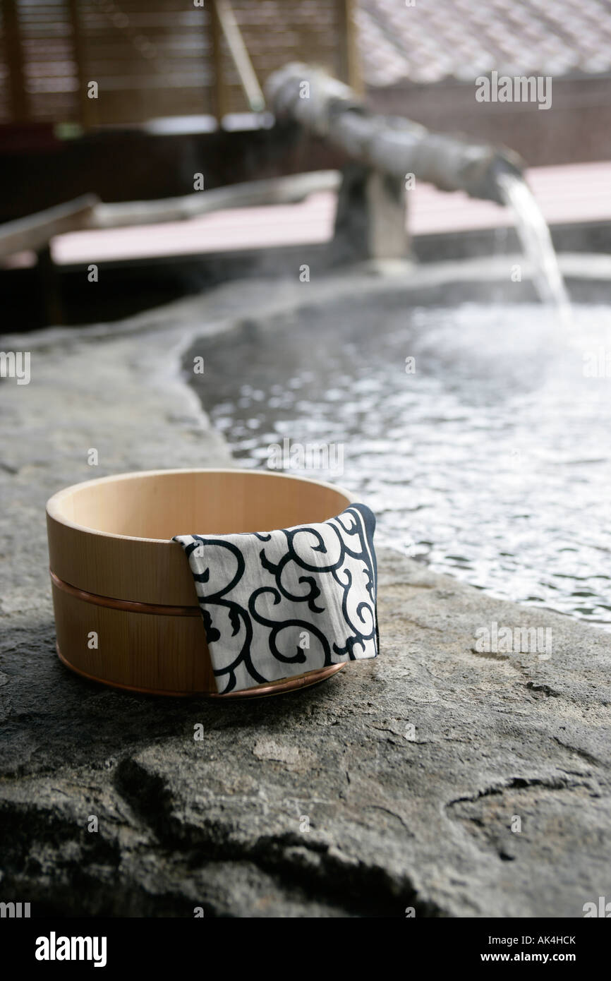Bucket and towel sitting on the ledge of hot tub Stock Photo - Alamy