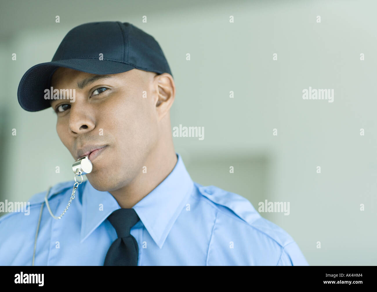 Security guard blowing whistle Stock Photo - Alamy