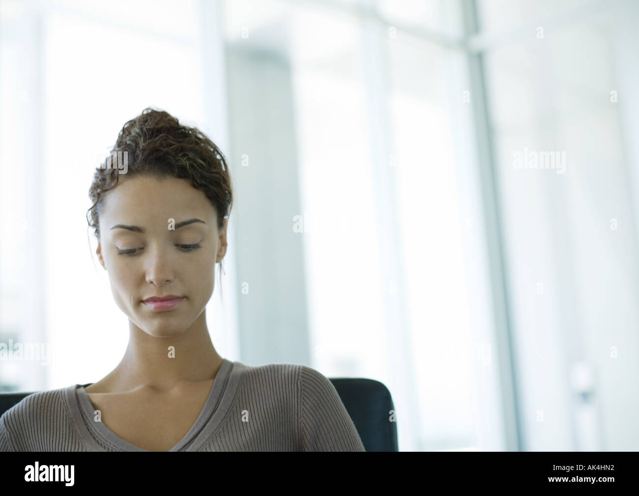 Woman looking down Stock Photo - Alamy