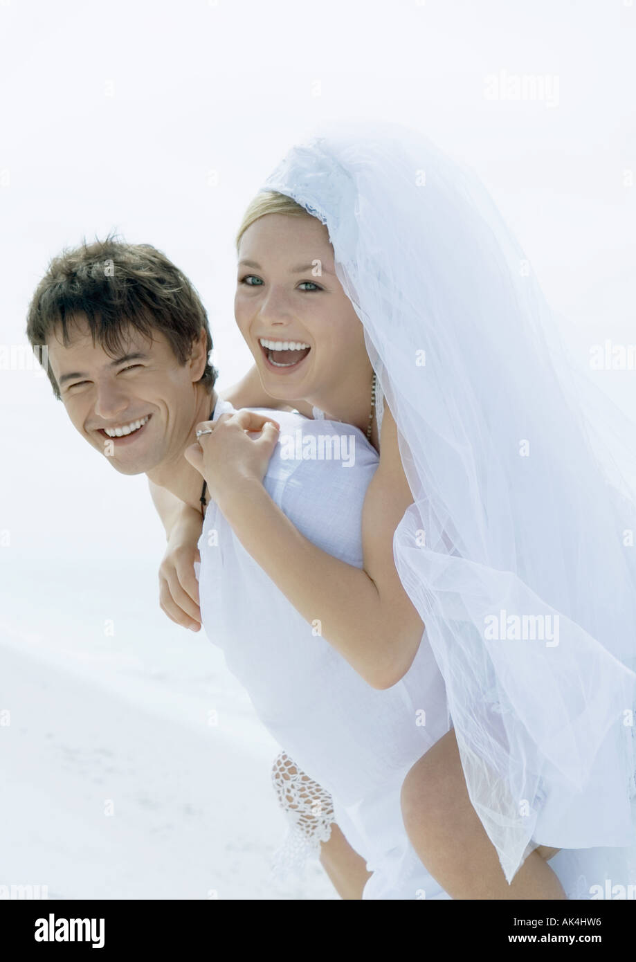 Bride riding piggyback on groom's back Stock Photo - Alamy