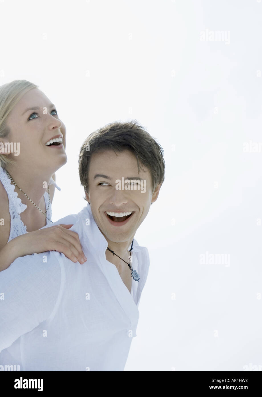 Woman on man's back, both laughing Stock Photo - Alamy