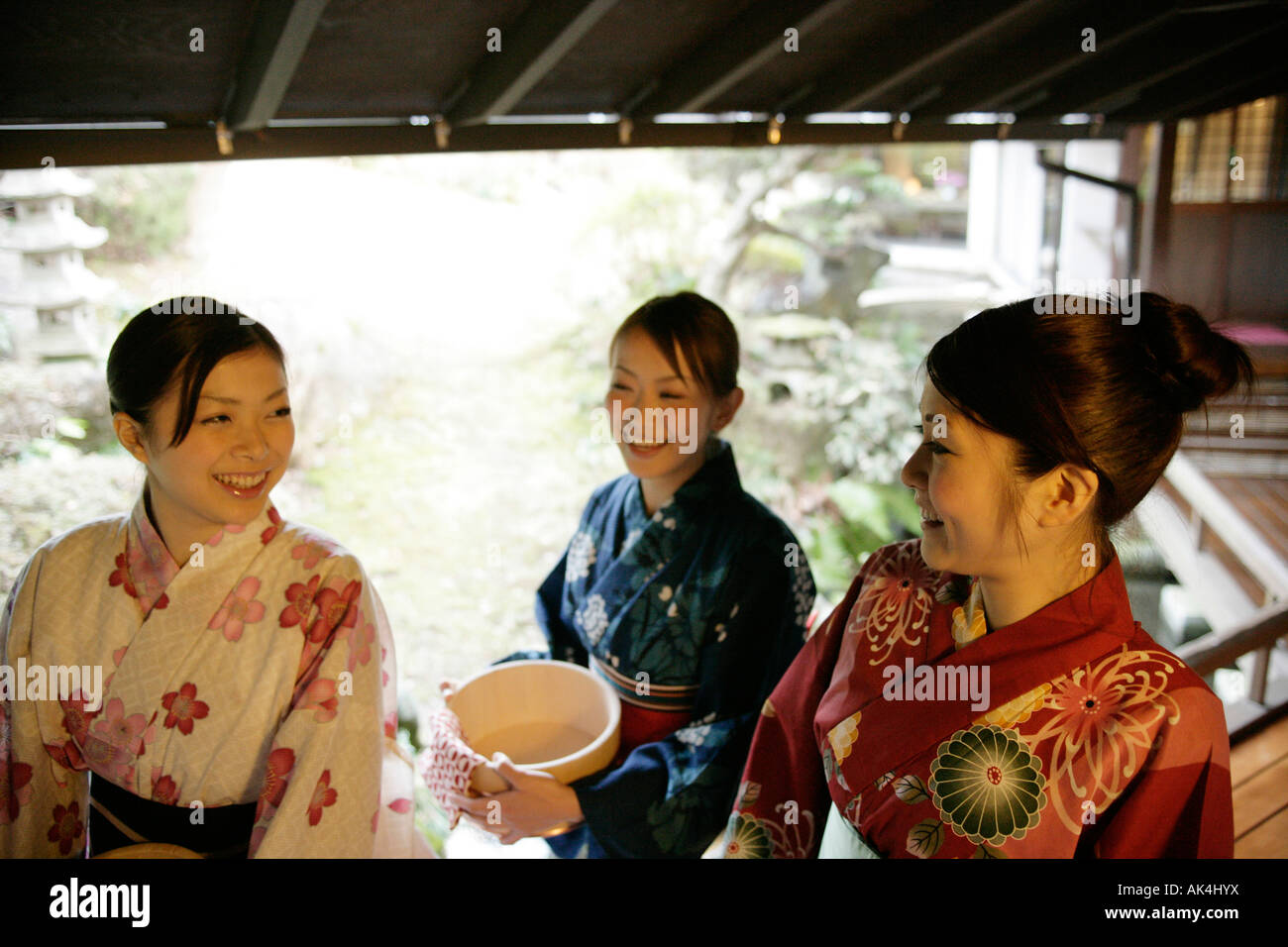 Three women in kimono walking along corridor, with buckets Stock Photo ...