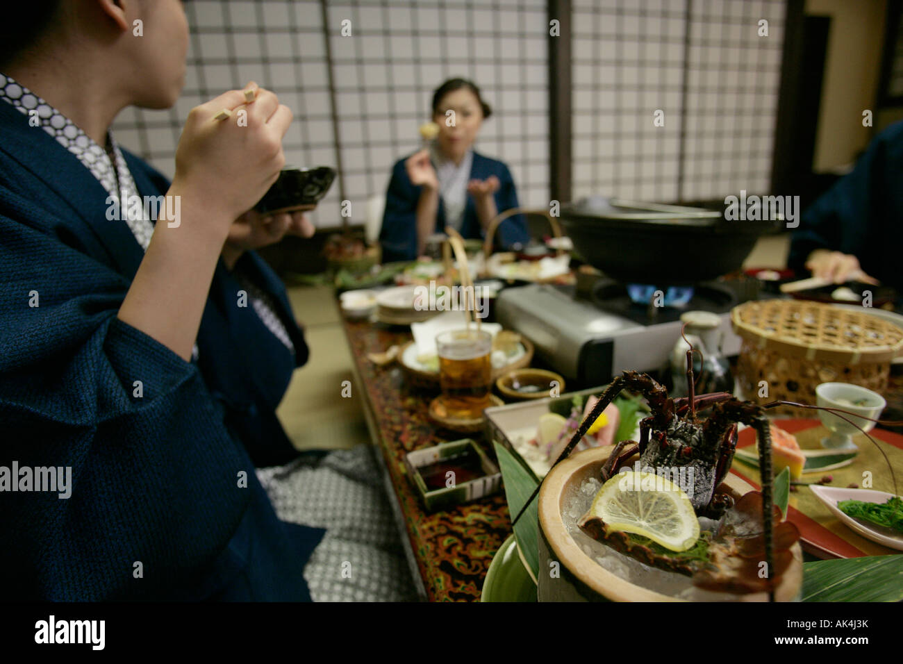 Two women tucking into a Japanese feast Stock Photo - Alamy