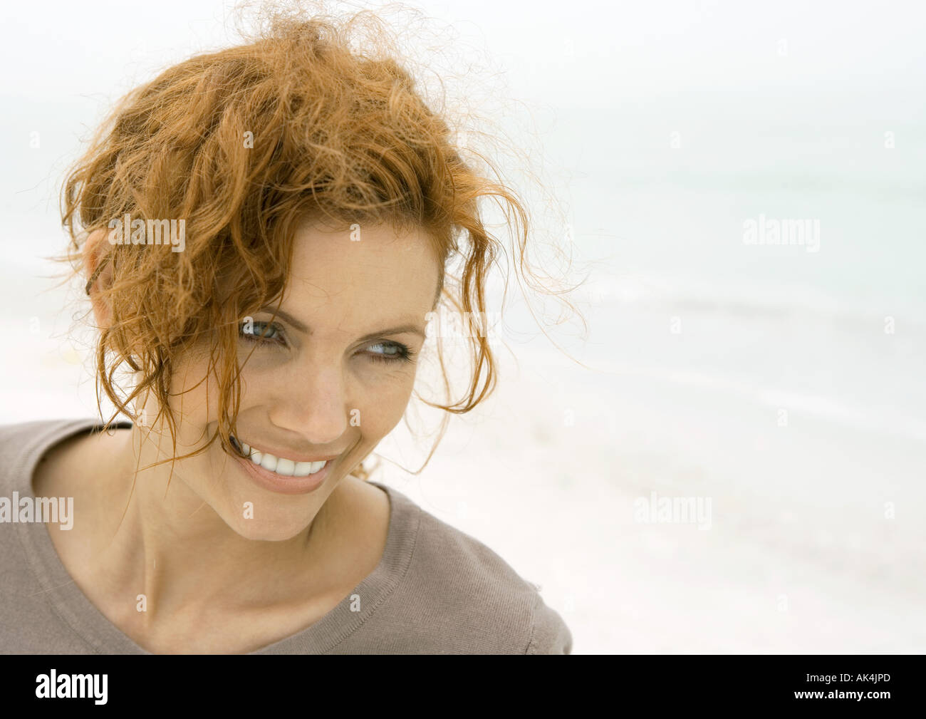 Woman smiling on beach Stock Photo - Alamy