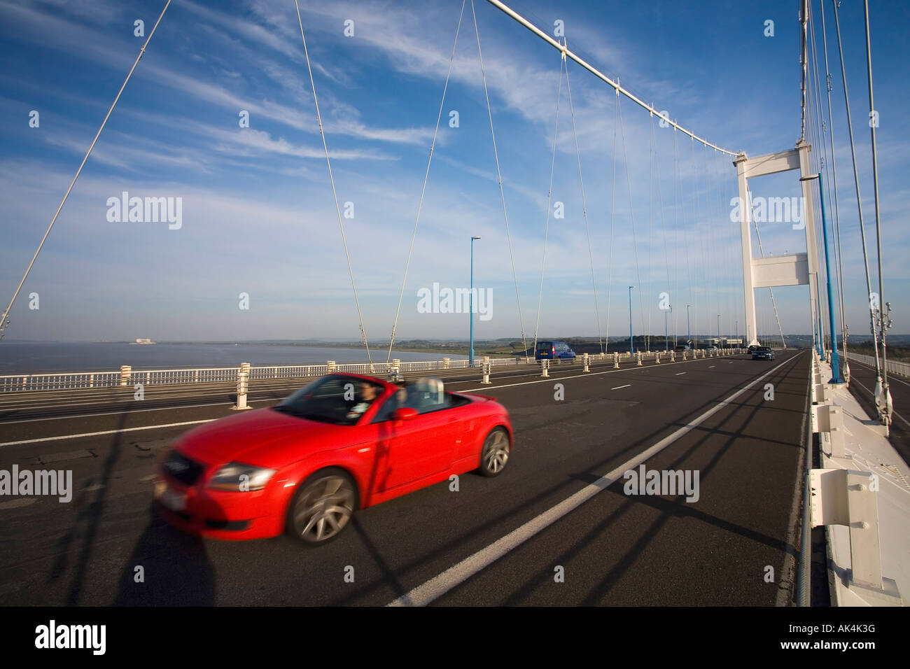 Old original severn road bridge on bright autumn day with sun and blue ...