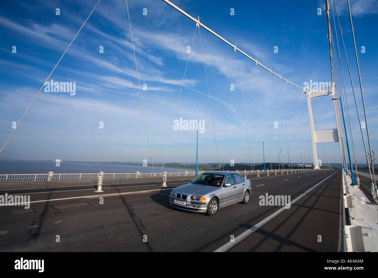 Old original severn road bridge on bright autumn day with sun and blue ...