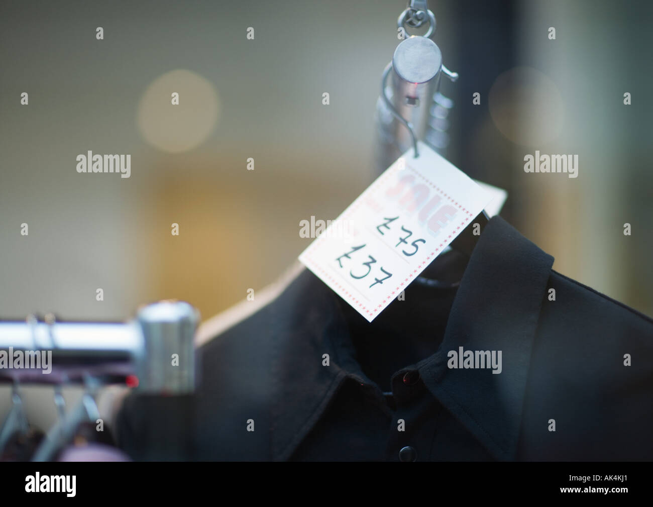 Clothing on rack, tag showing sale price Stock Photo - Alamy