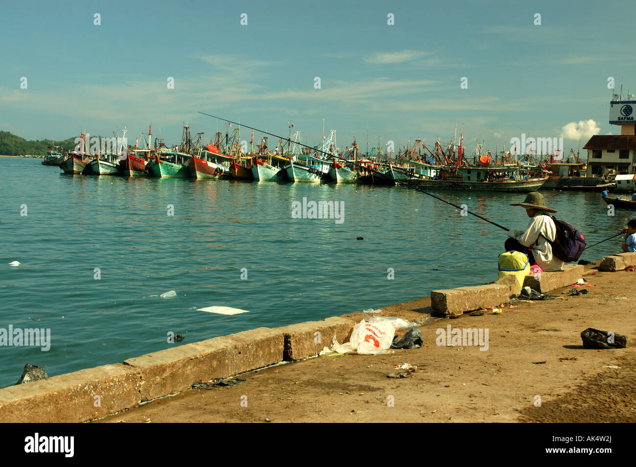 fisherman on the port of kota kinabalu in borneo Stock Photo - Alamy