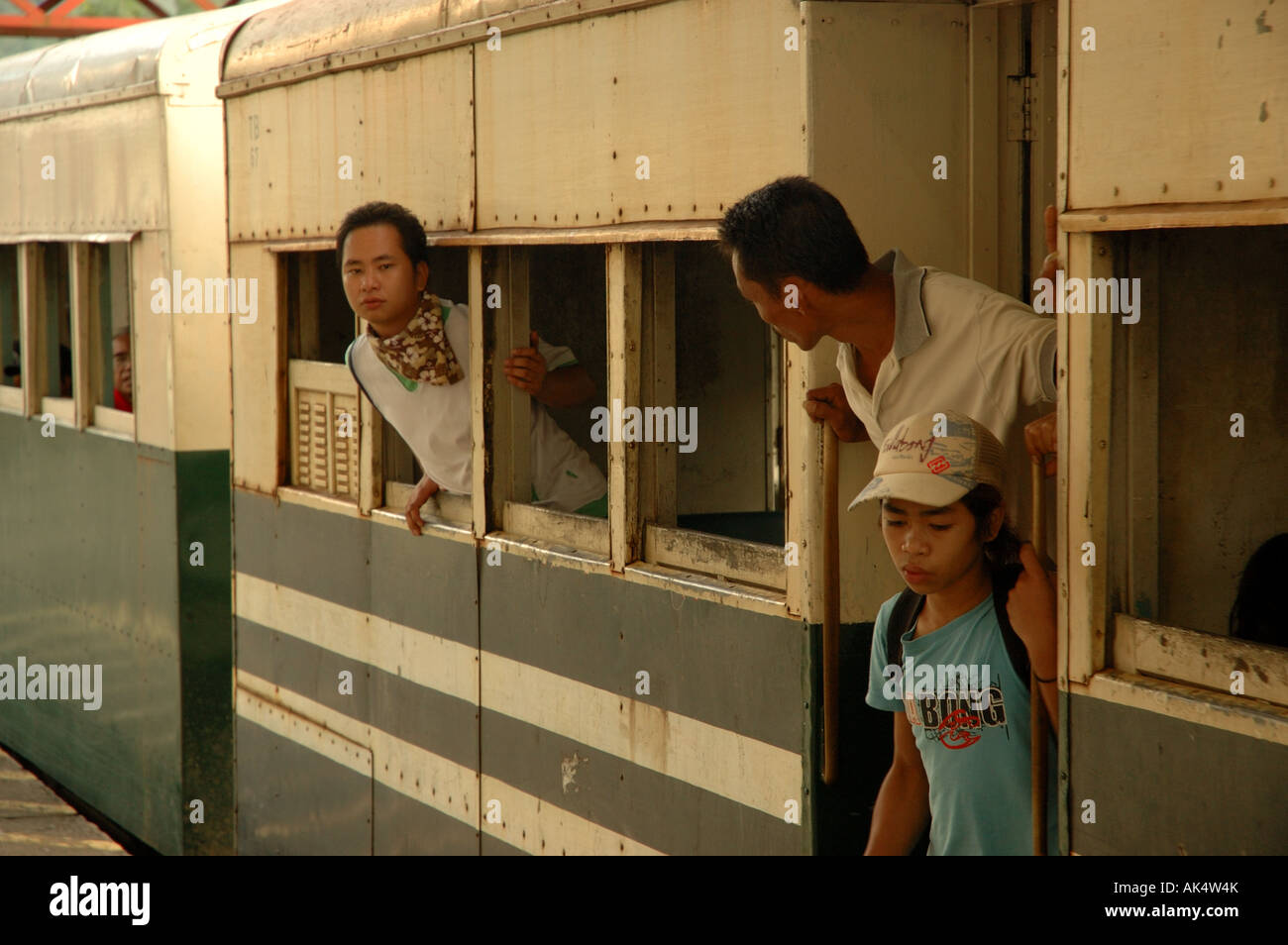 passengers hanging out of a window on a train in borneo Stock Photo - Alamy