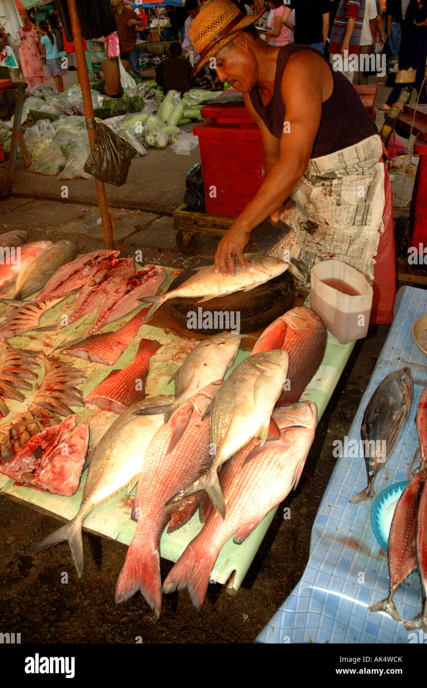 Fishmonger chopping fish in a market in Kota Kinabalu in Borneo Stock ...
