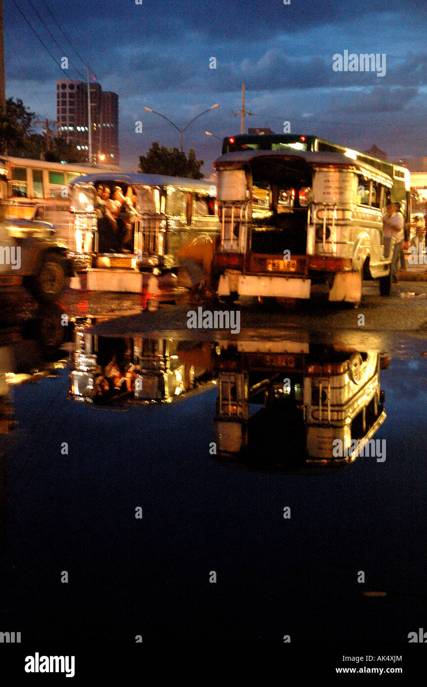 Two Jeepneys reflecting in a puddle at night in Manila, Philippines ...