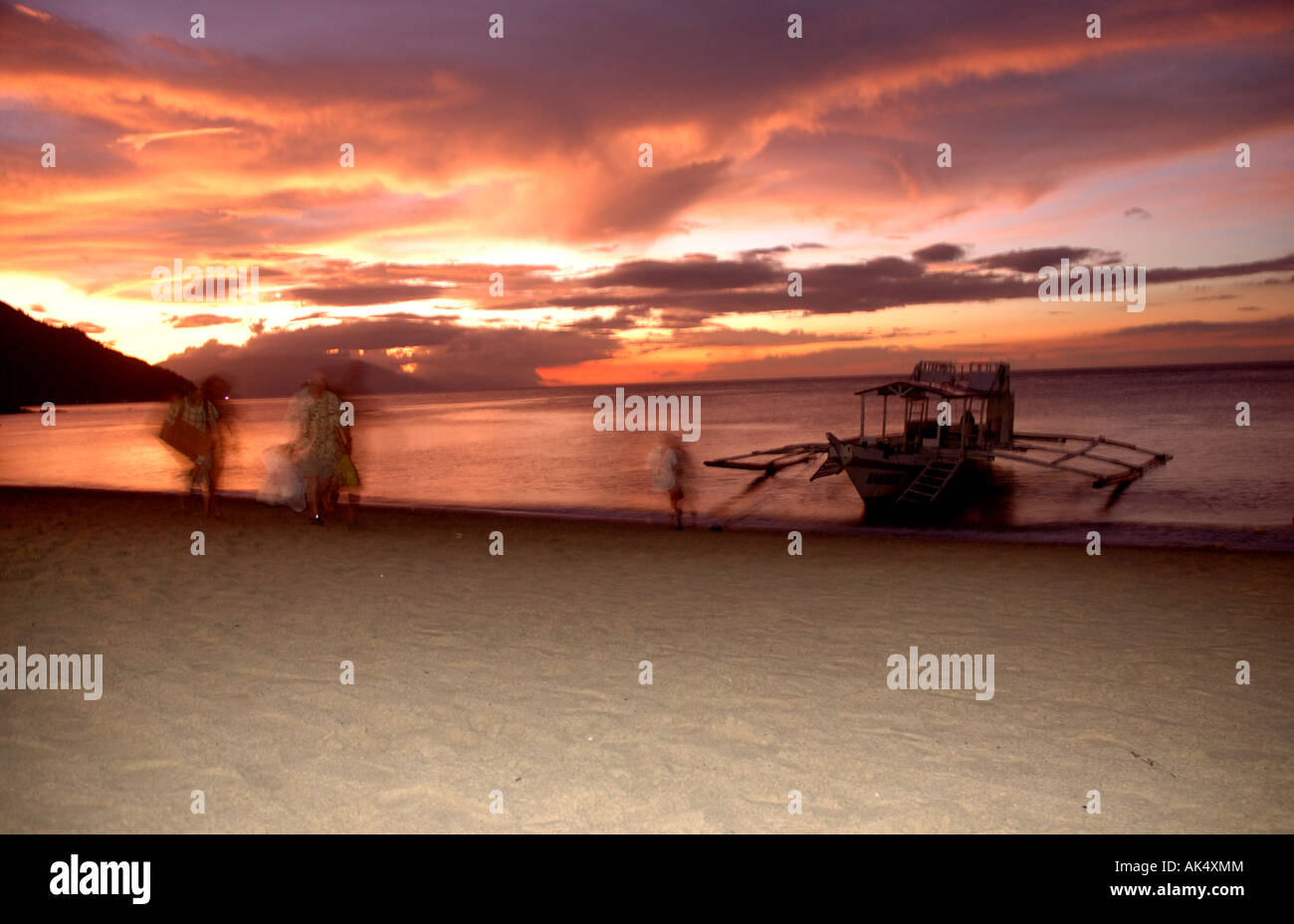 Boat and sunset on White Beach in Mindoro, Philippines Stock Photo - Alamy