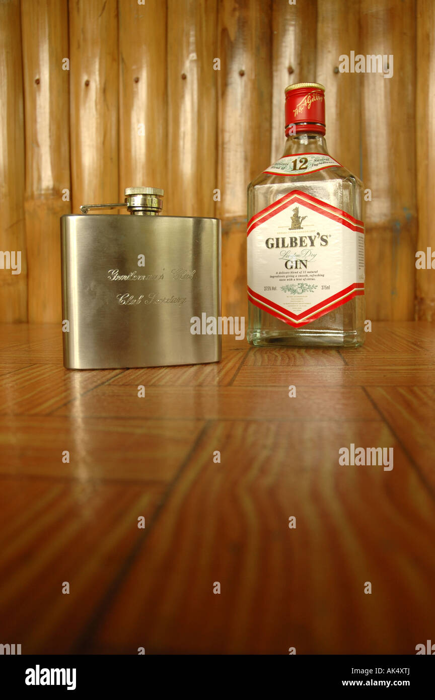 Gilbys Gin and hip flask on a table Stock Photo - Alamy