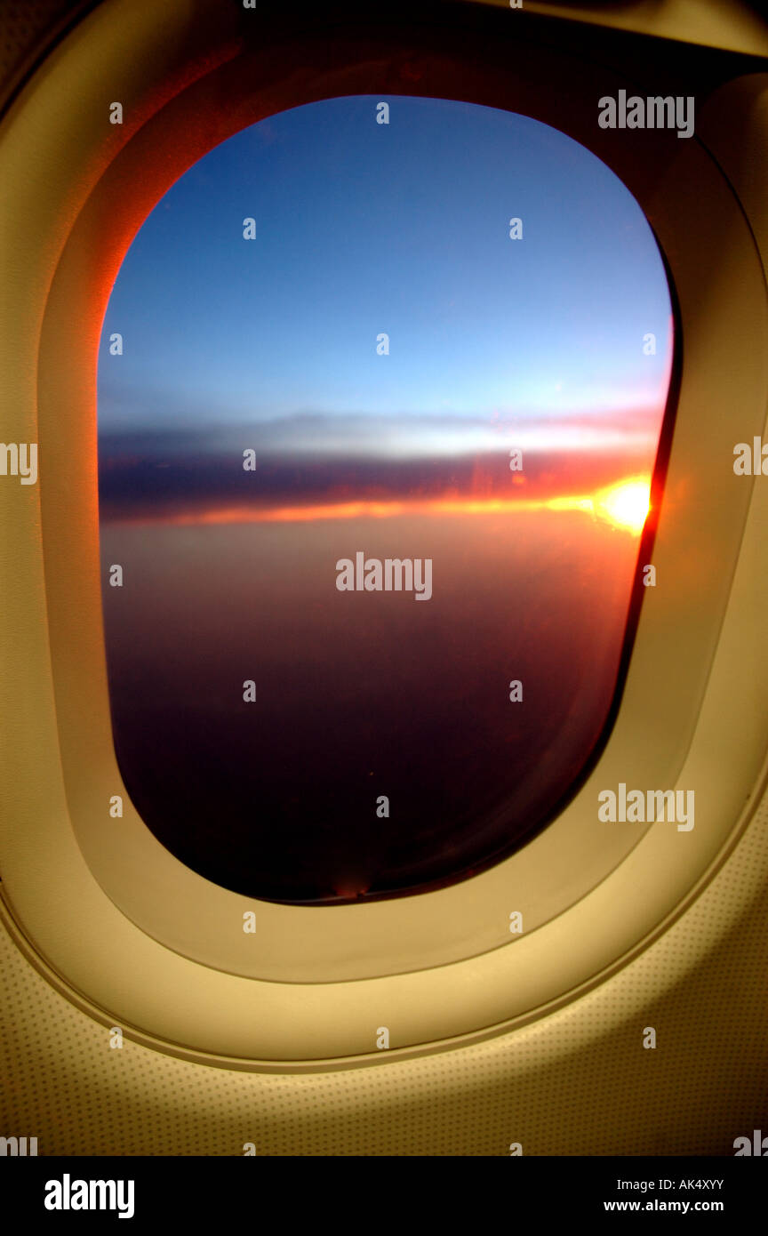 Sunset over Asia through a Plane window Stock Photo - Alamy