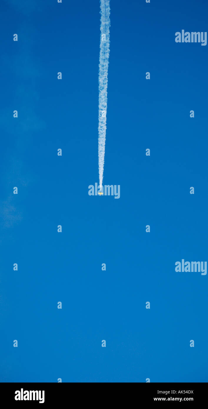 yellow jet high overhead with smoke trail Stock Photo - Alamy