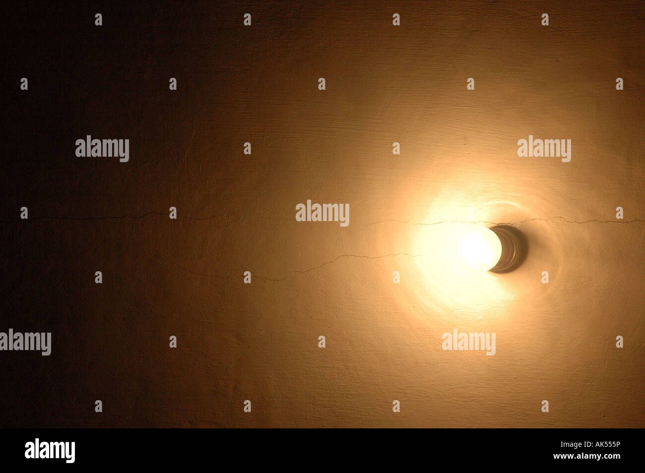 A light illuminated on a white wall Stock Photo - Alamy