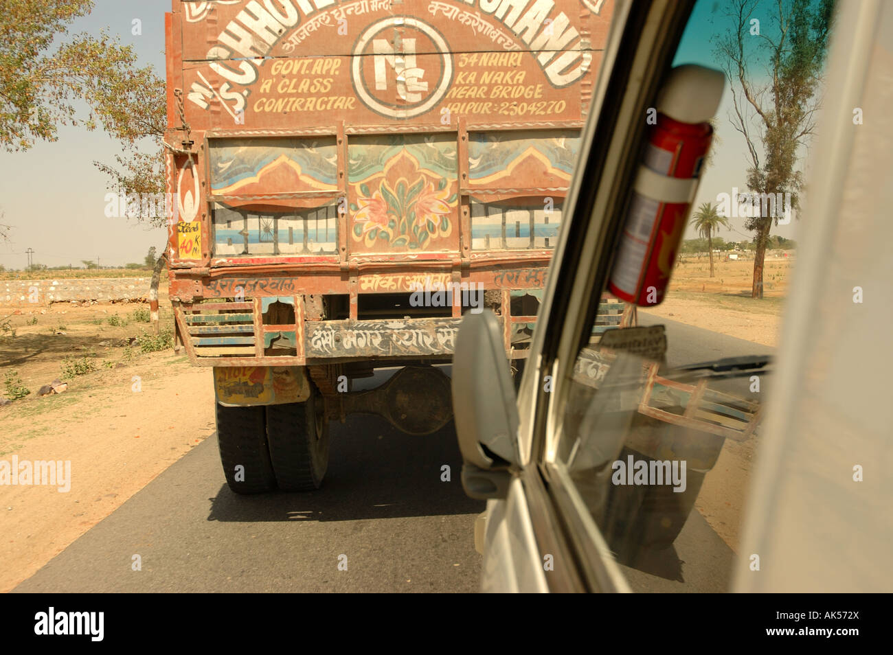 Scary driving in India. A car driving too close to the back of a truck ...
