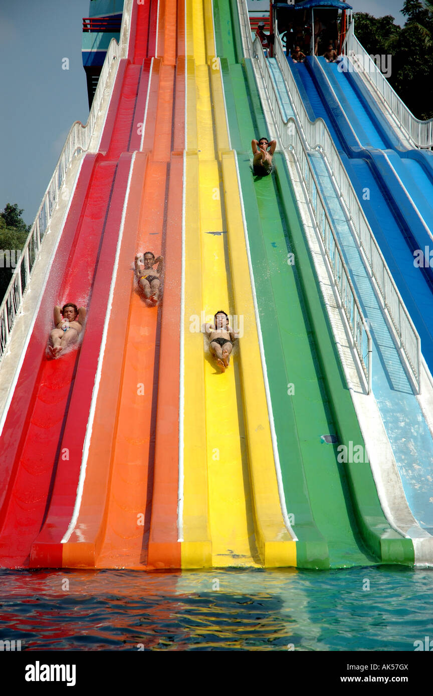 Four people descending a Colourful waterslide in Bangkok water park ...