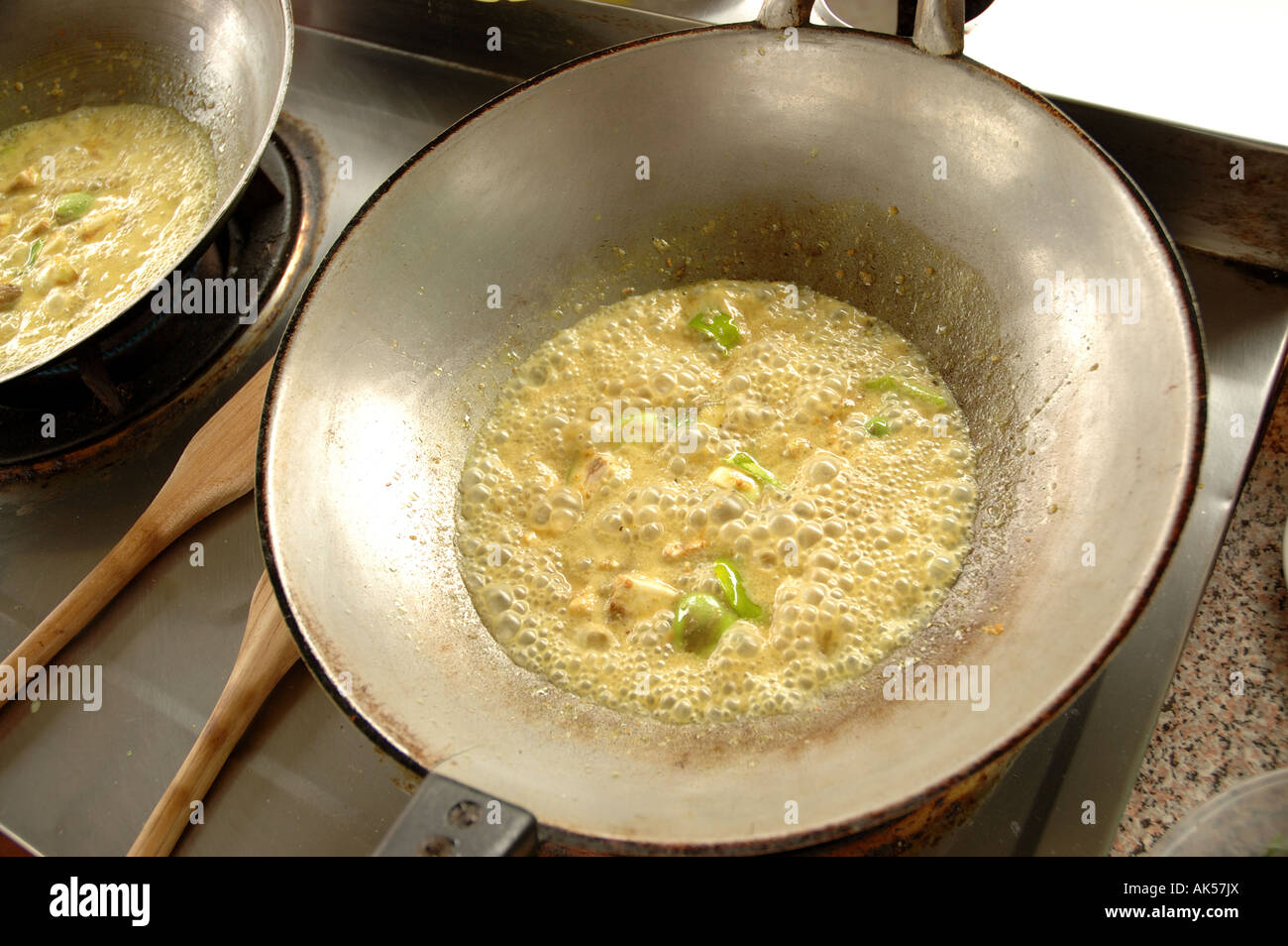 Thai Green curry being cooked in a wok Stock Photo - Alamy