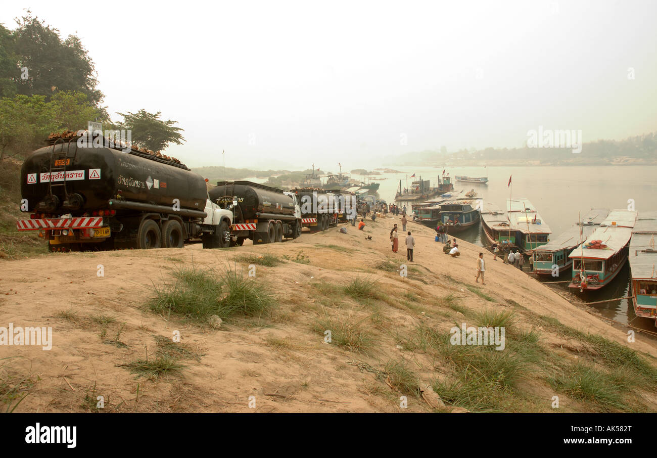 Passenger boats and oil tanker on Mekong River in Laos and a ferry ...