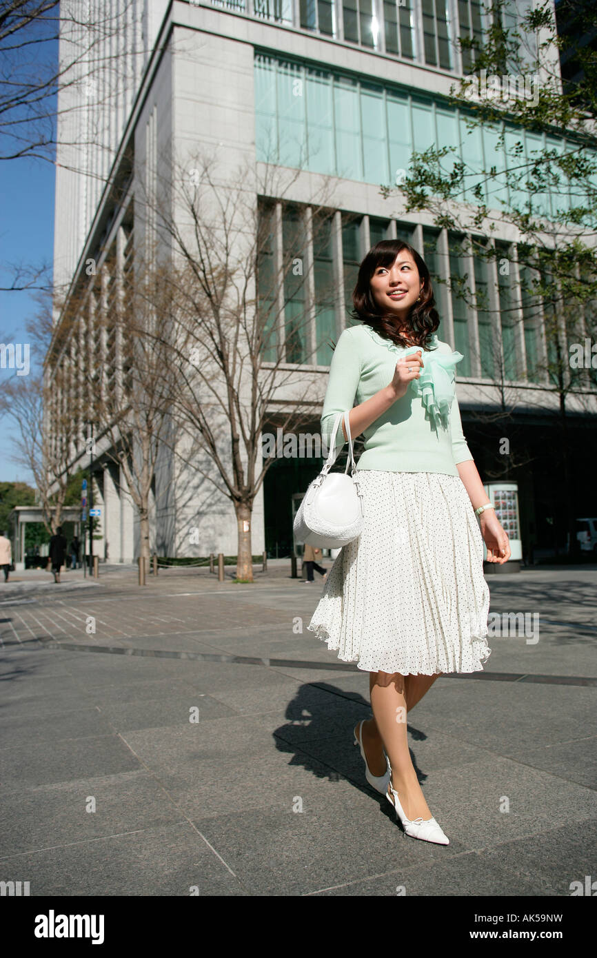 Woman standing on the street, outside a building Stock Photo - Alamy