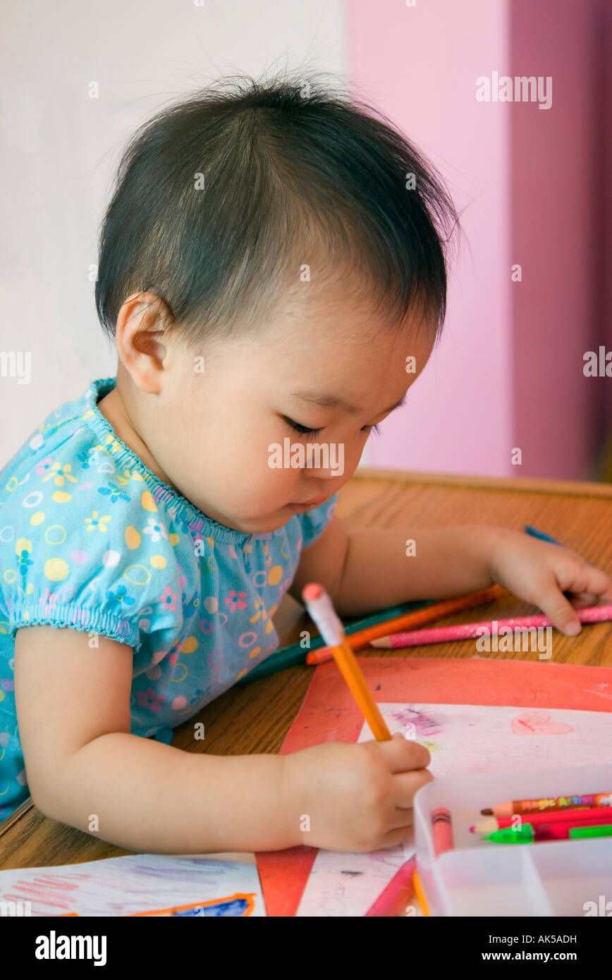 Toddler drawing with a pencil Stock Photo - Alamy