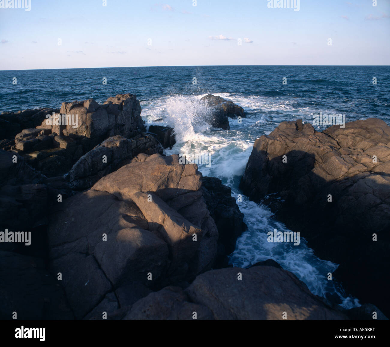 waves splashing onto rocks at sea Stock Photo - Alamy