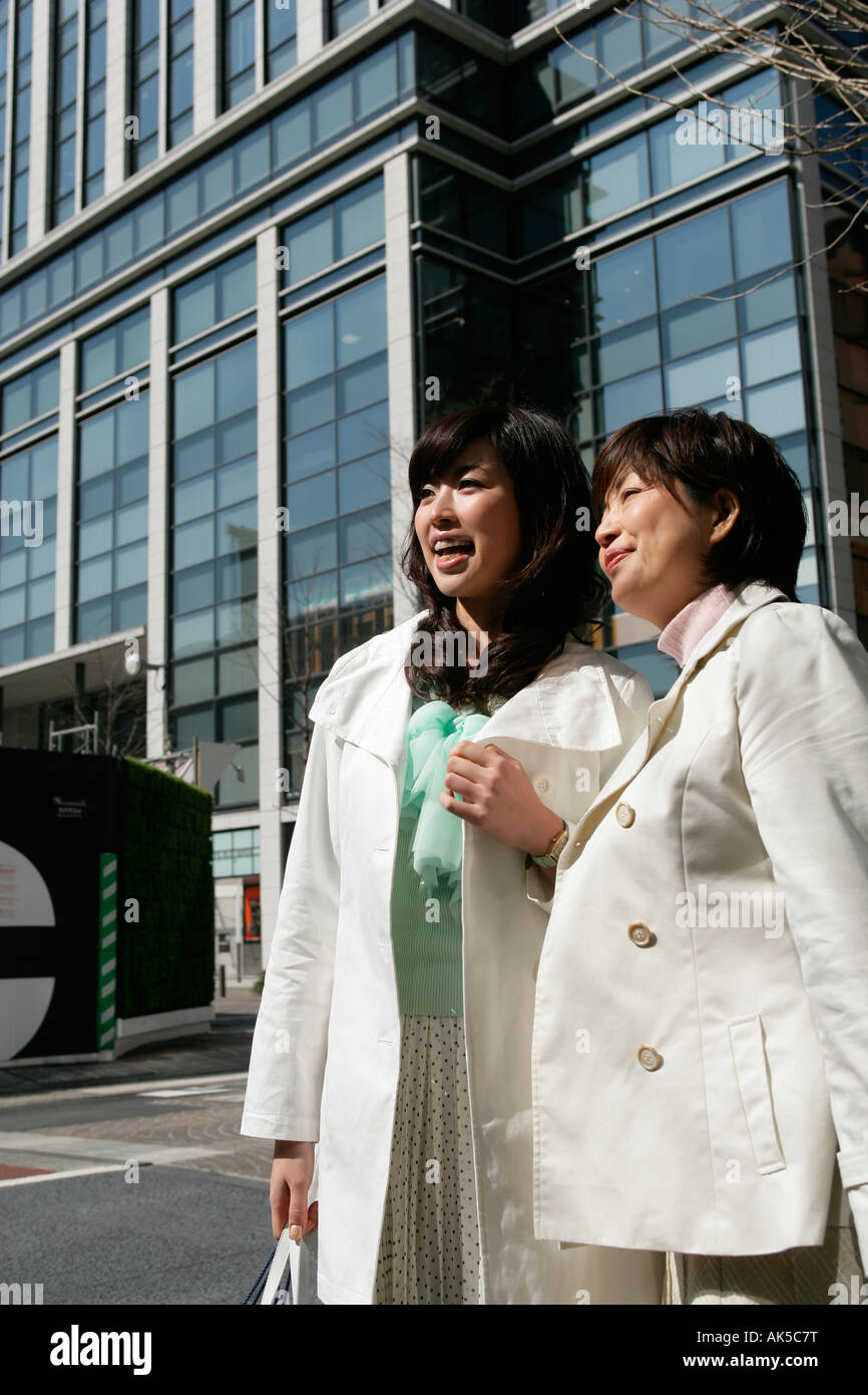Two women standing outside a building Stock Photo - Alamy