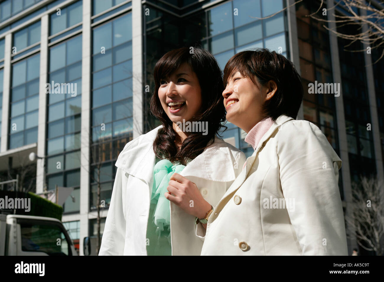 Two women standing outside a building, close-up Stock Photo - Alamy