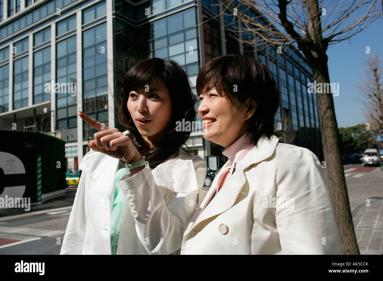 Two women standing outside a building Stock Photo - Alamy