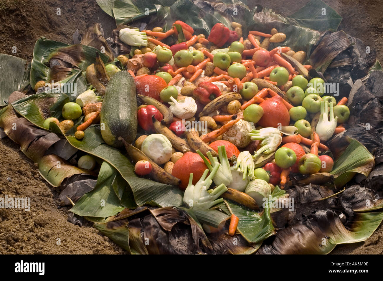 curanto cooking in the earth oven vegetables cooking over hot stones ...